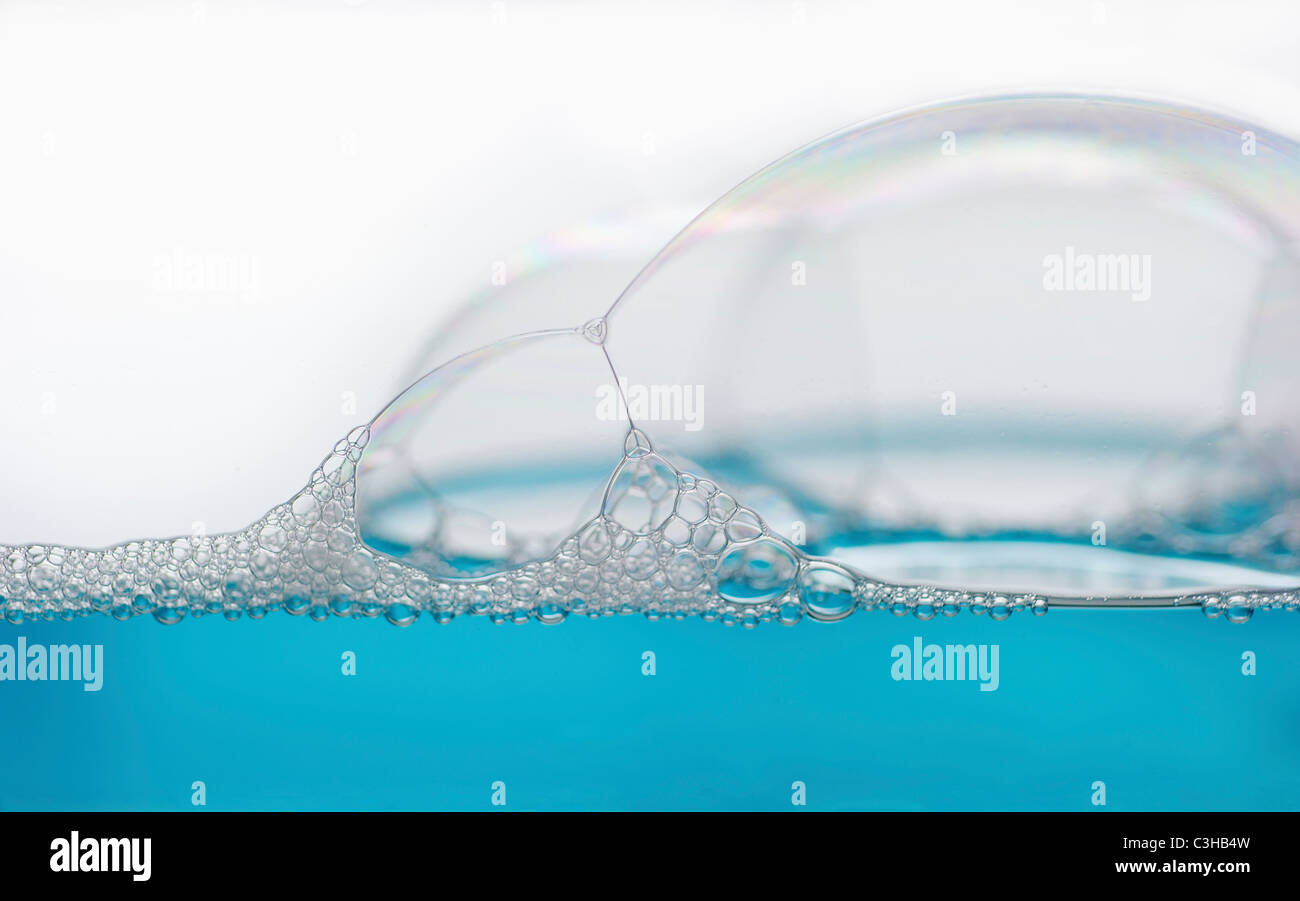 Close up of soap bubbles on water surface Stock Photo - Alamy