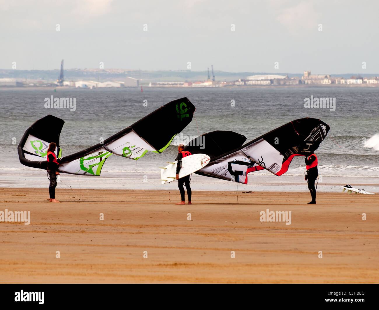 Competitors carrying parasails at a Kiteval or Kite surfing Festival ...