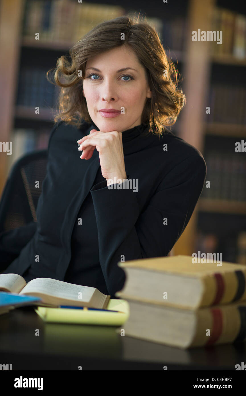 Portrait of woman studying in library Stock Photo - Alamy