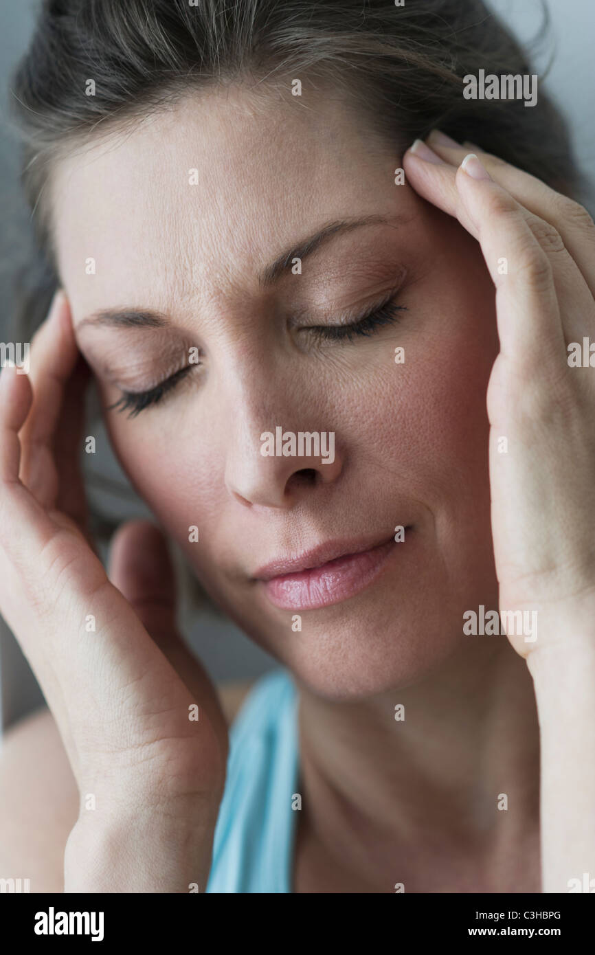 Close up of woman with headache touching head Stock Photo - Alamy