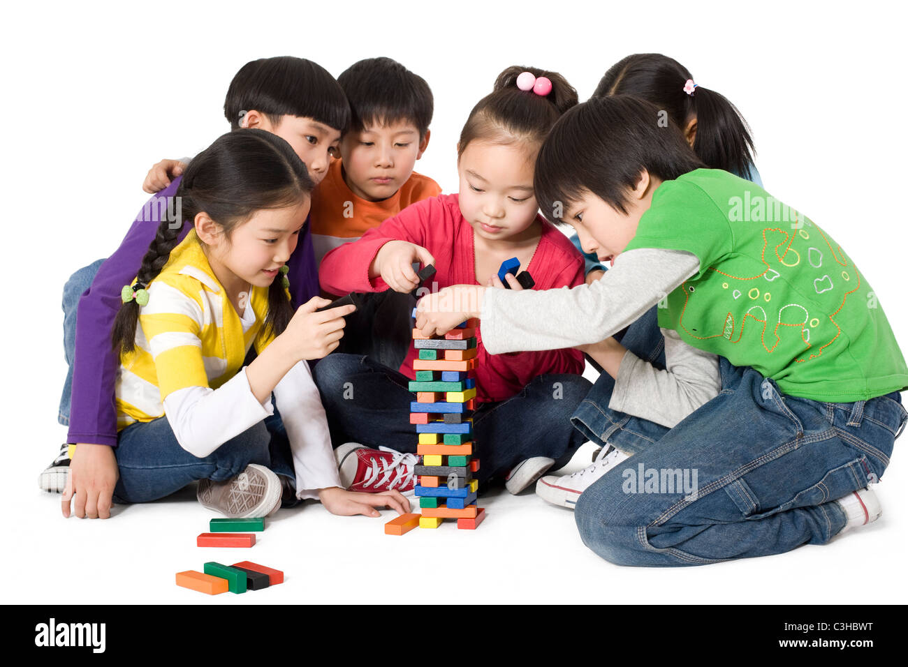 A group of children playing a wooden block game Stock Photo - Alamy