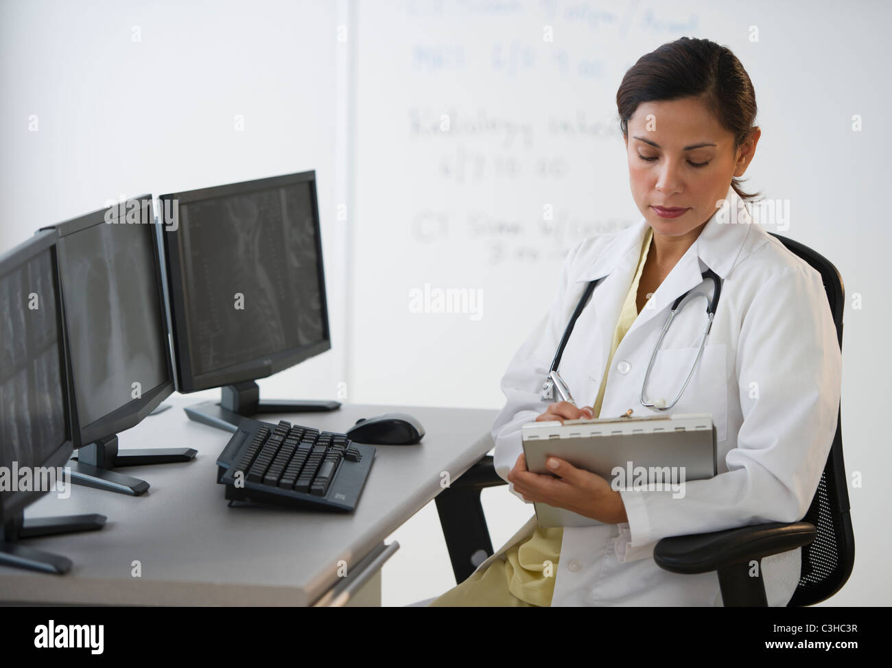 Female doctor making notes Stock Photo - Alamy