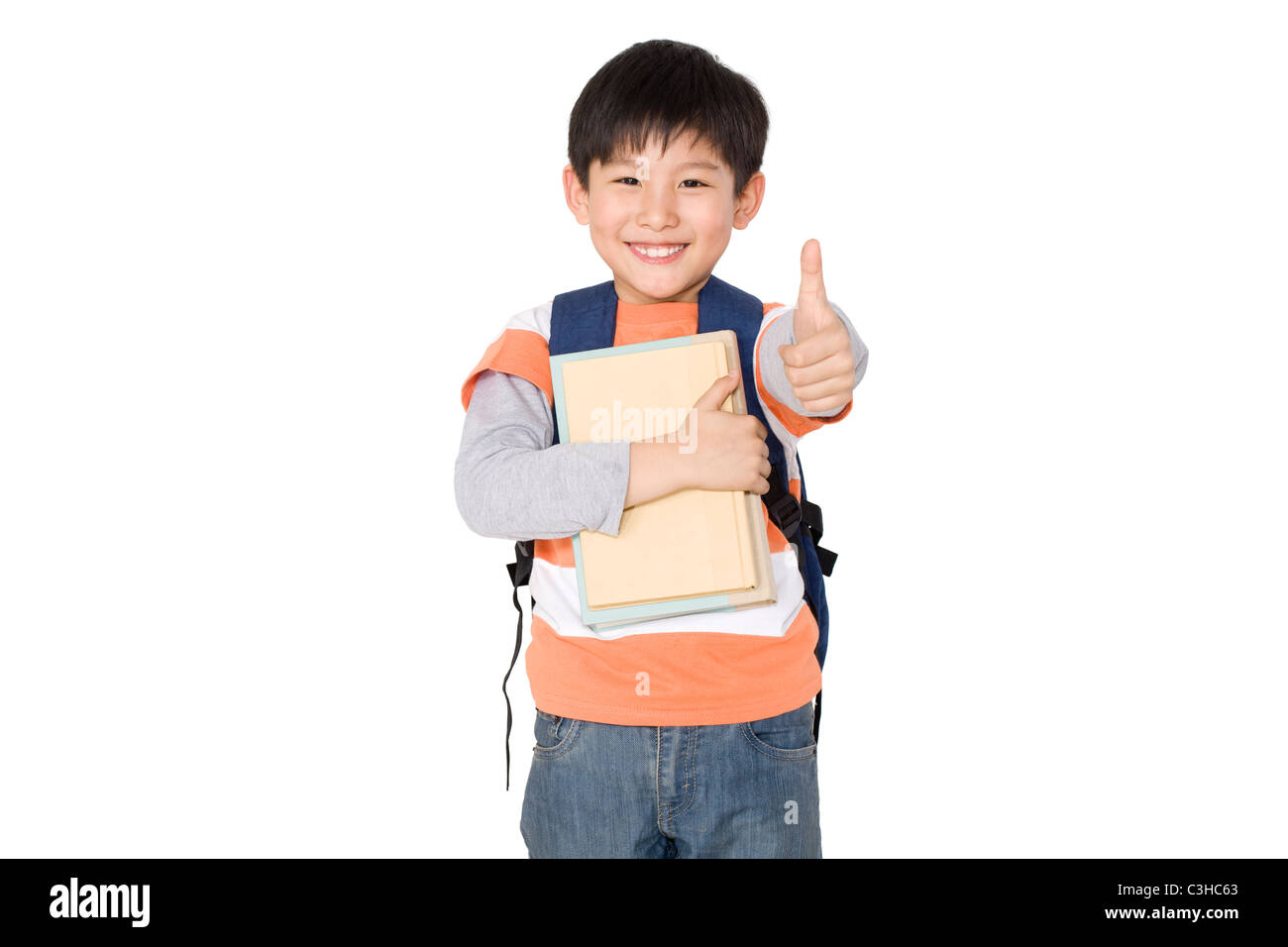 A young boy holding books and giving a thumbs up Stock Photo - Alamy