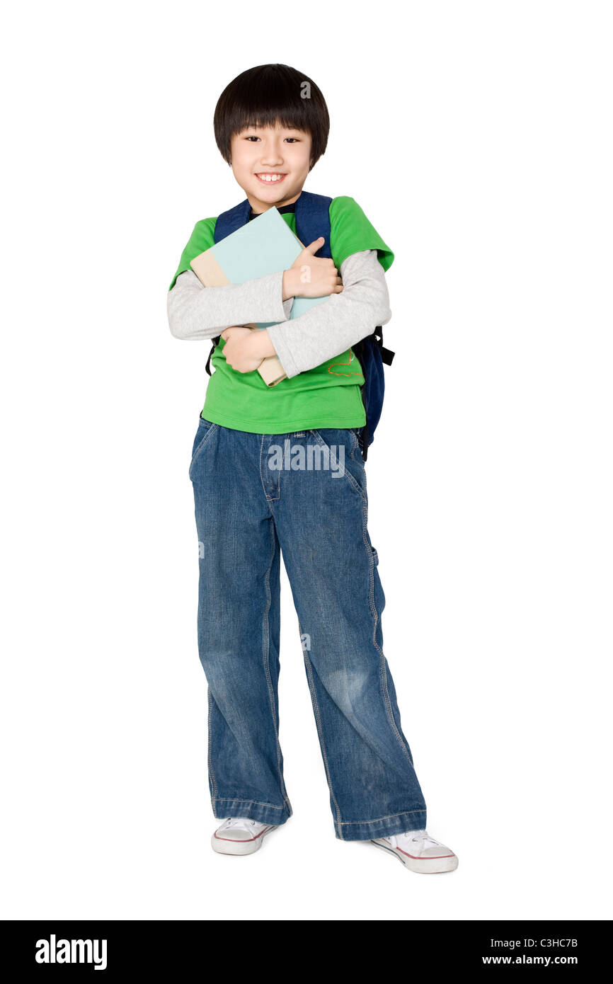 A young boy holding his books Stock Photo - Alamy