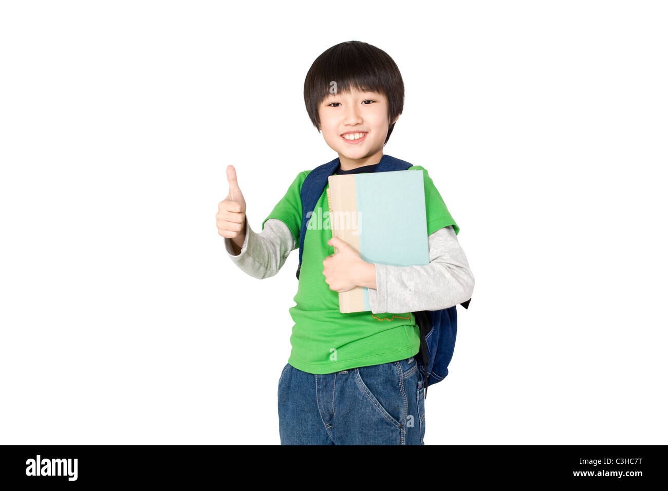 A young boy holding books and giving a thumbs up Stock Photo - Alamy