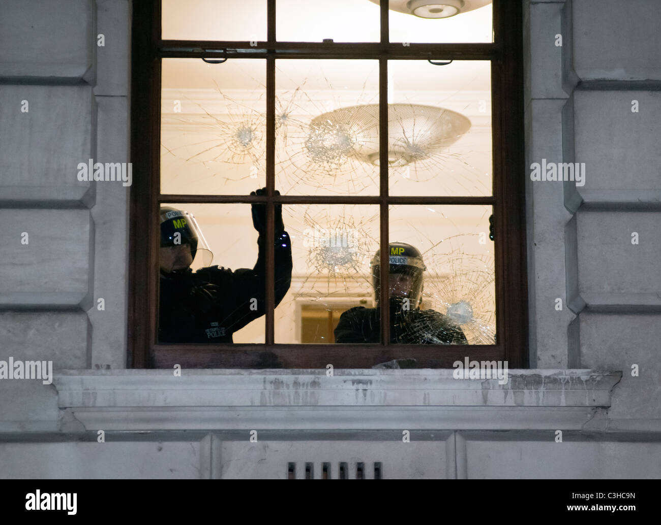 Riot police secure windows after student fees protesters attacked the ...
