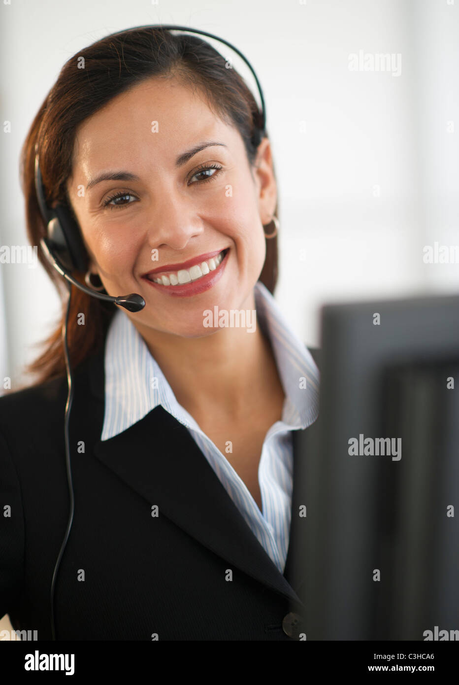 Smiling female customer service representative with headset Stock Photo - Alamy