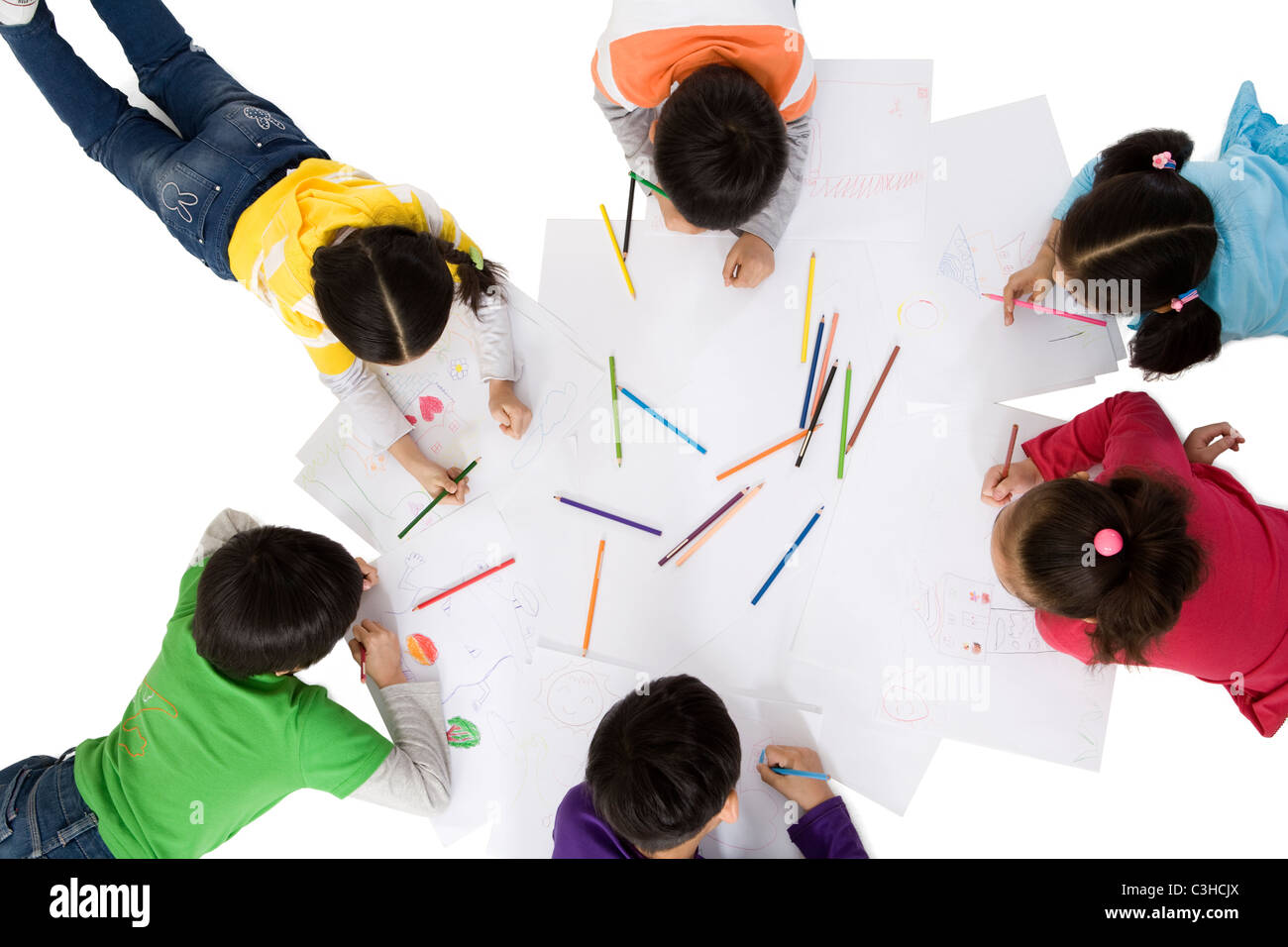A group of children coloring together on the floor Stock Photo - Alamy