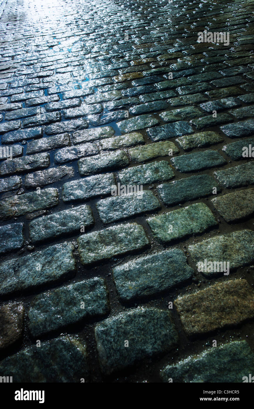 Close up of cobblestone street at night Stock Photo - Alamy