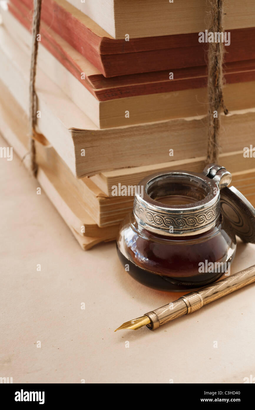 Close up antique ink well, pen and books Stock Photo - Alamy