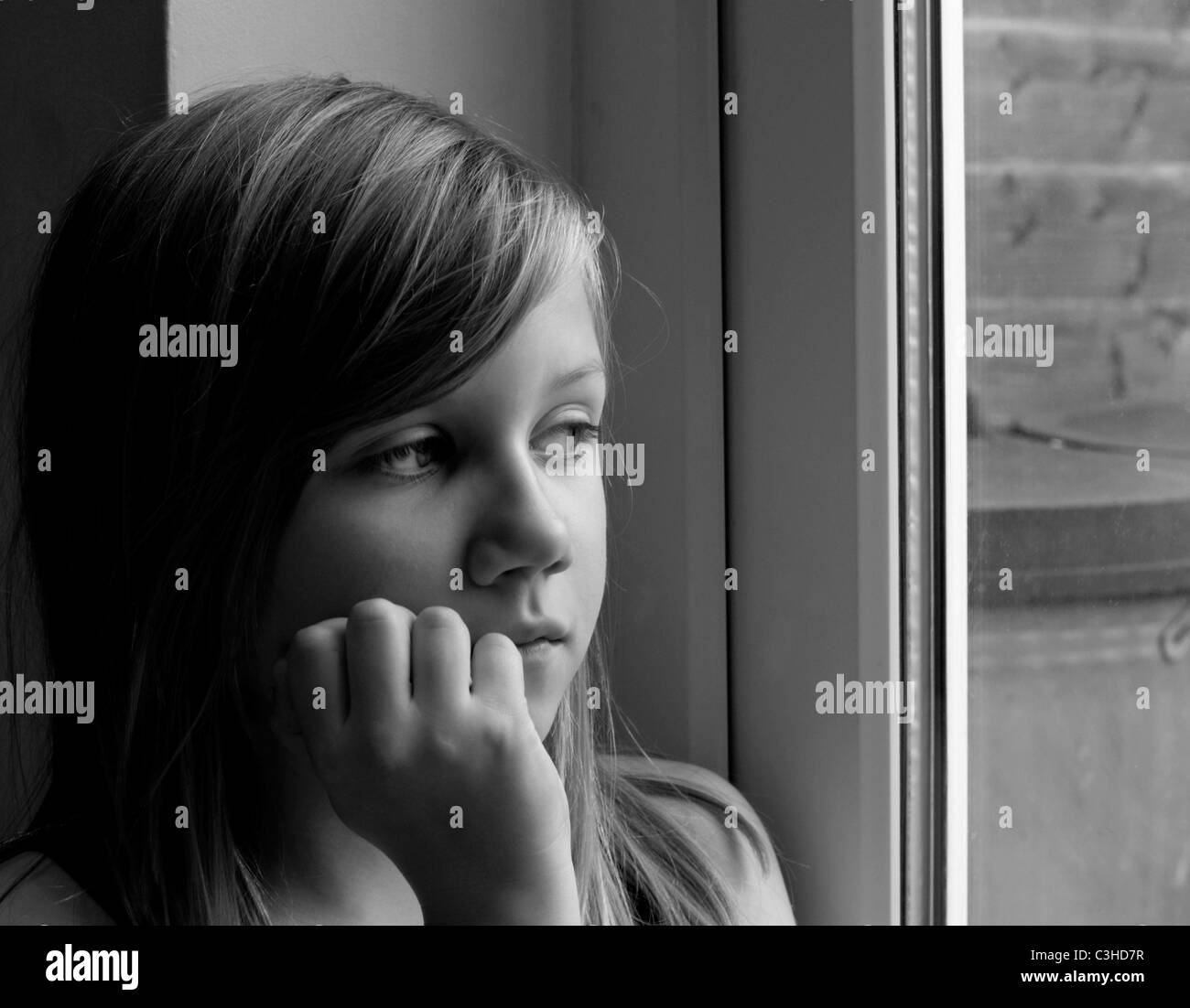 Girl afraid alone window Black and White Stock Photos & Images - Alamy