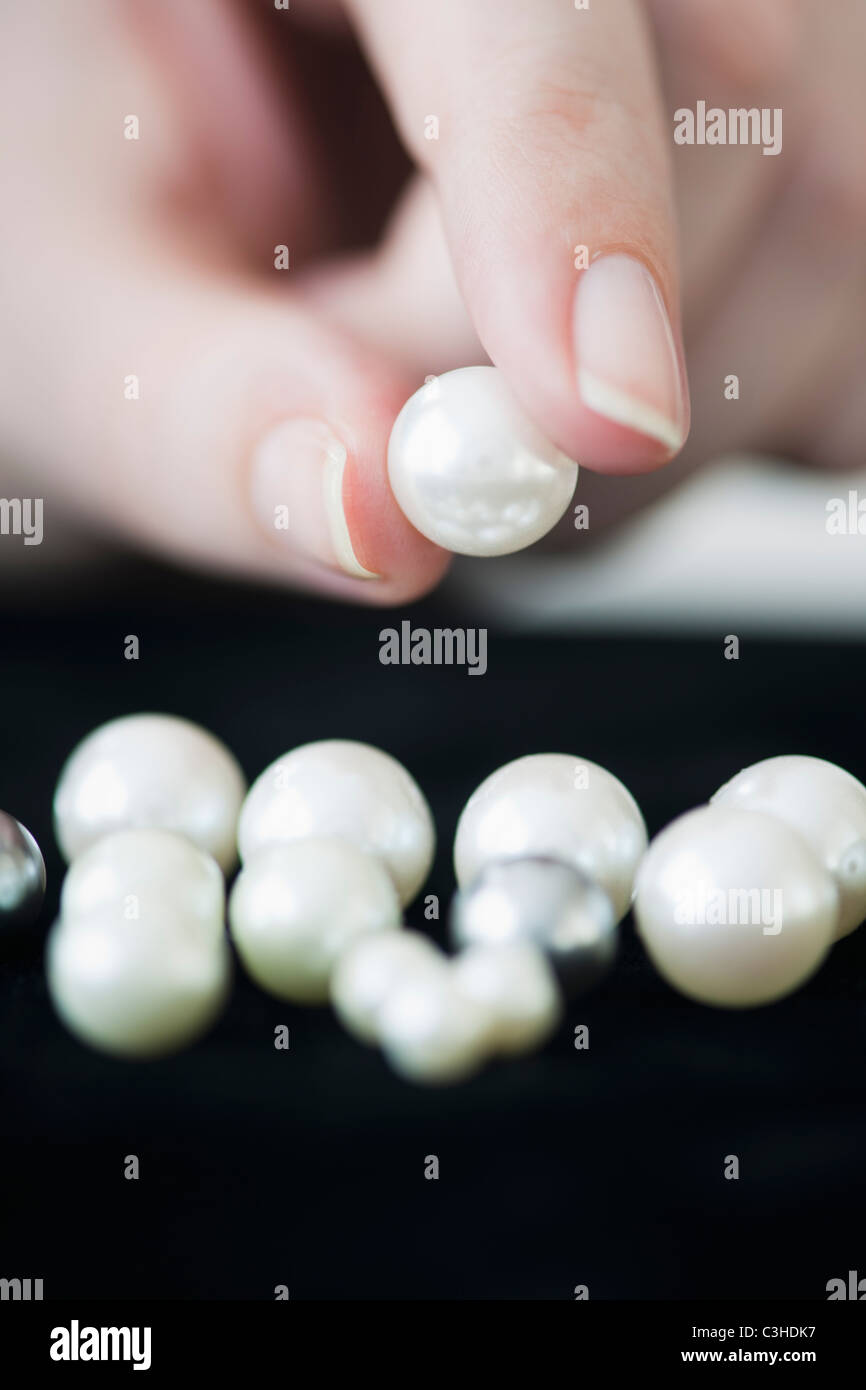 Woman holding pearl Stock Photo - Alamy