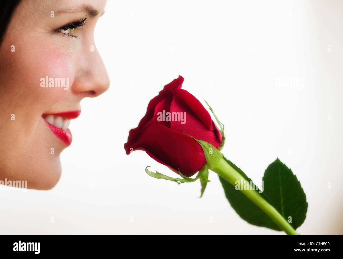 Woman smelling scented rose hi-res stock photography and images - Alamy