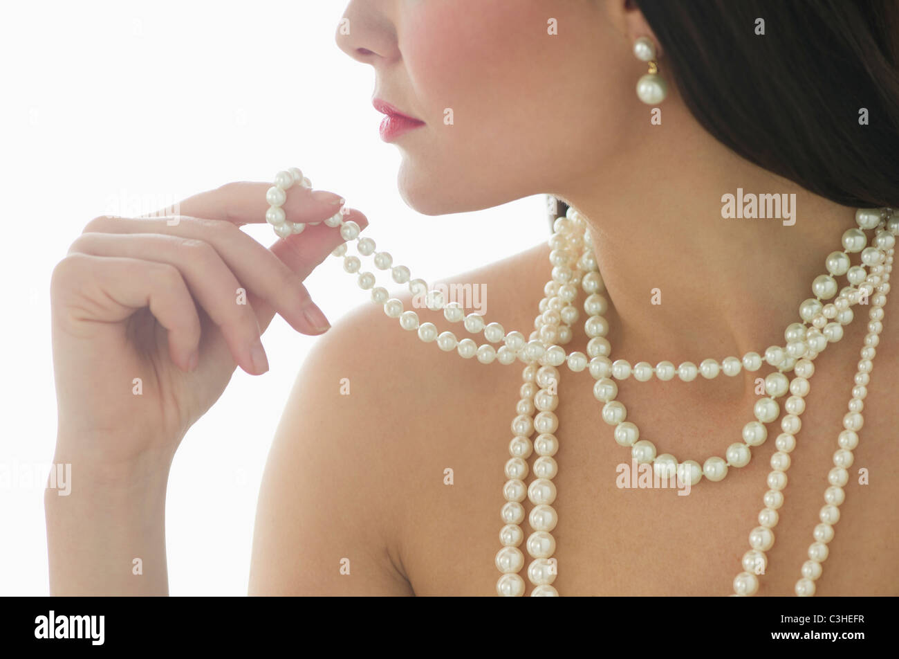 Profile of young woman wearing pearls Stock Photo - Alamy