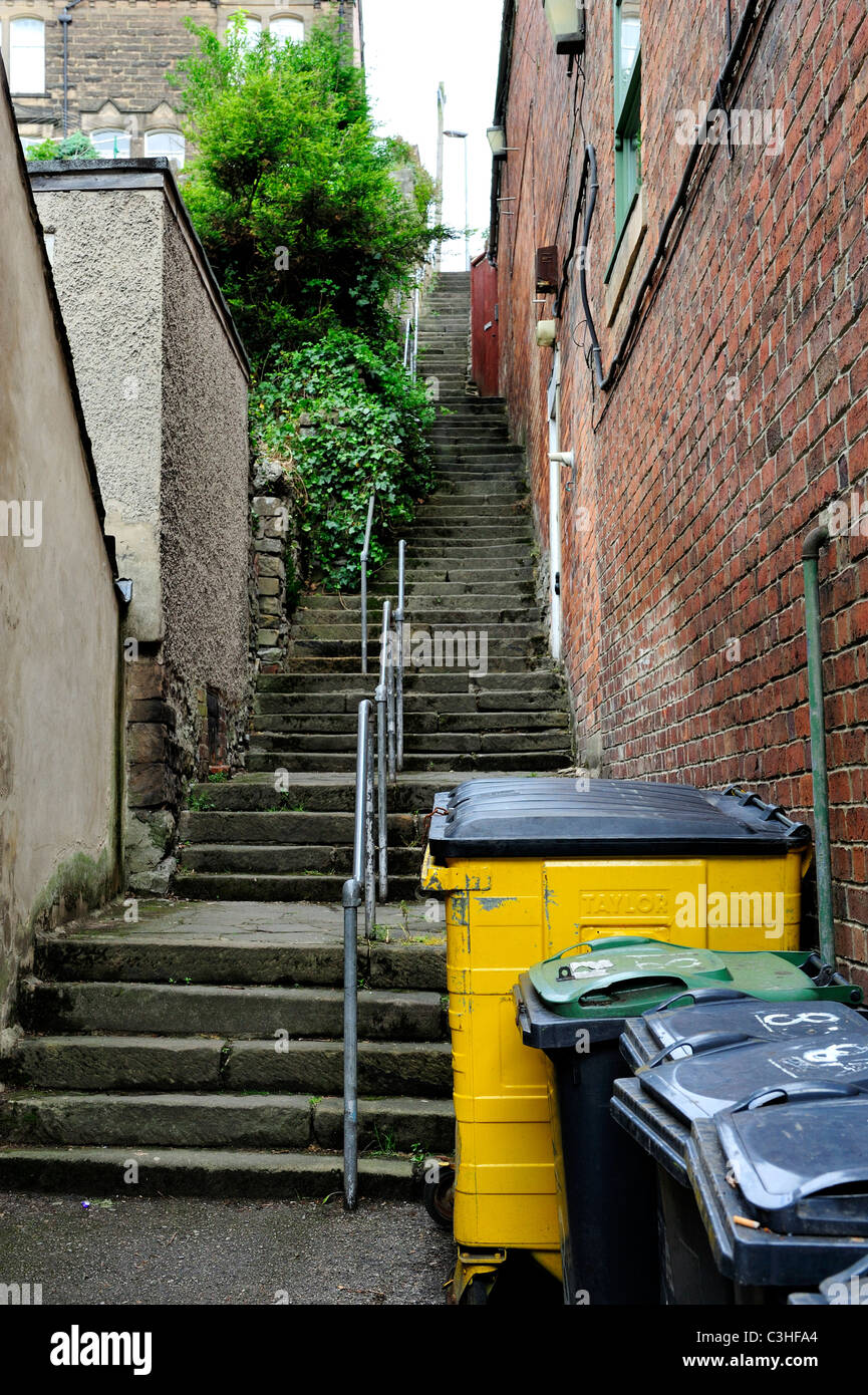domestic waste bins up a side street at the bottom of some steps ...