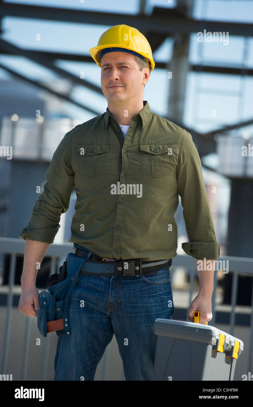 Manual worker at construction site Stock Photo - Alamy