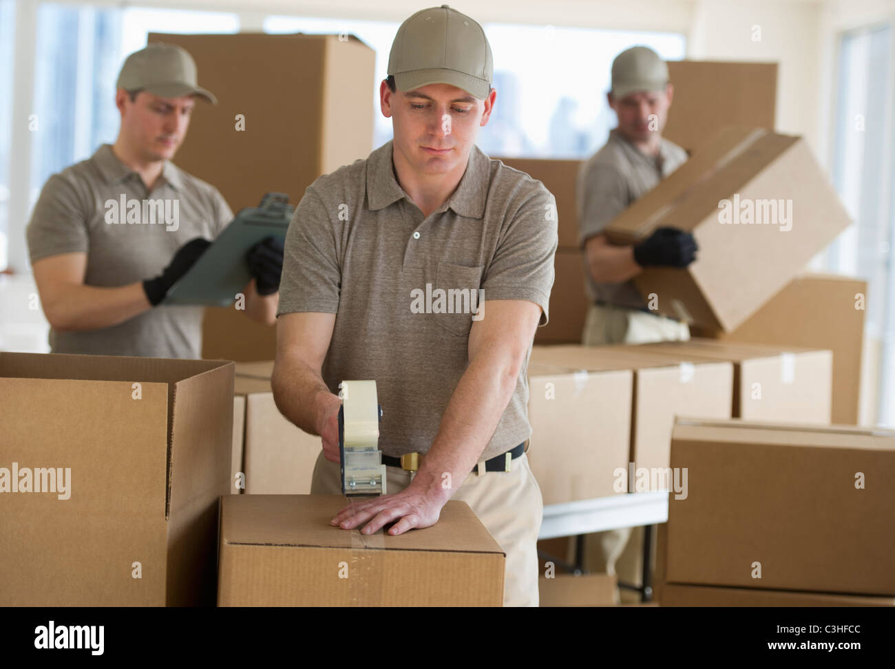 Men packing boxes in warehouse Stock Photo - Alamy