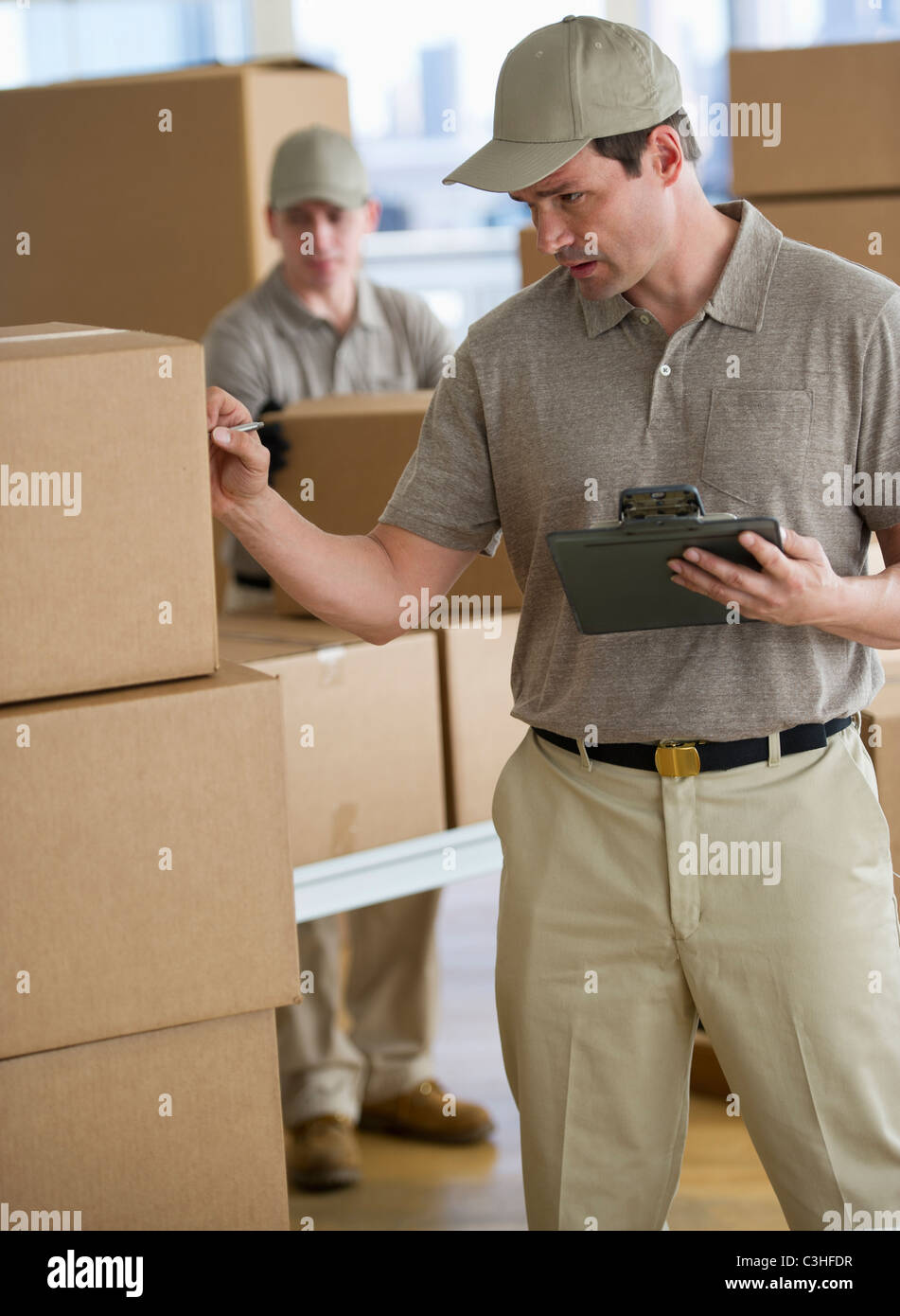 Man checking checklist in warehouse Stock Photo - Alamy