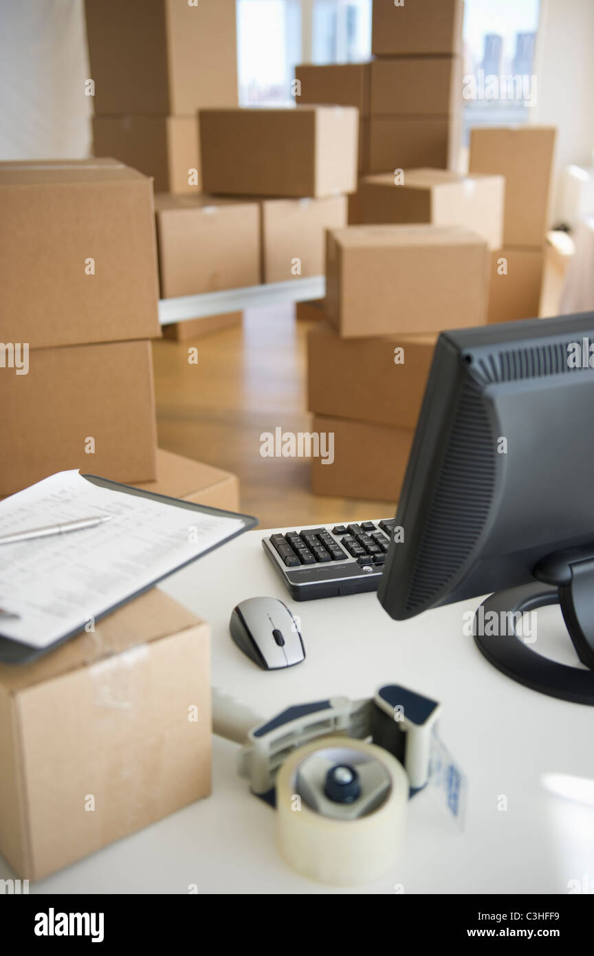 Boxes and computer at delivery warehouse Stock Photo - Alamy