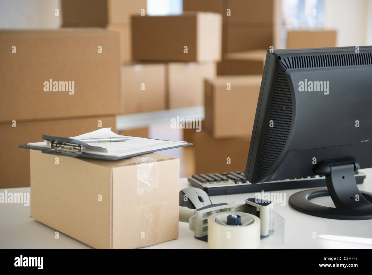 Boxes and computer at delivery warehouse Stock Photo - Alamy