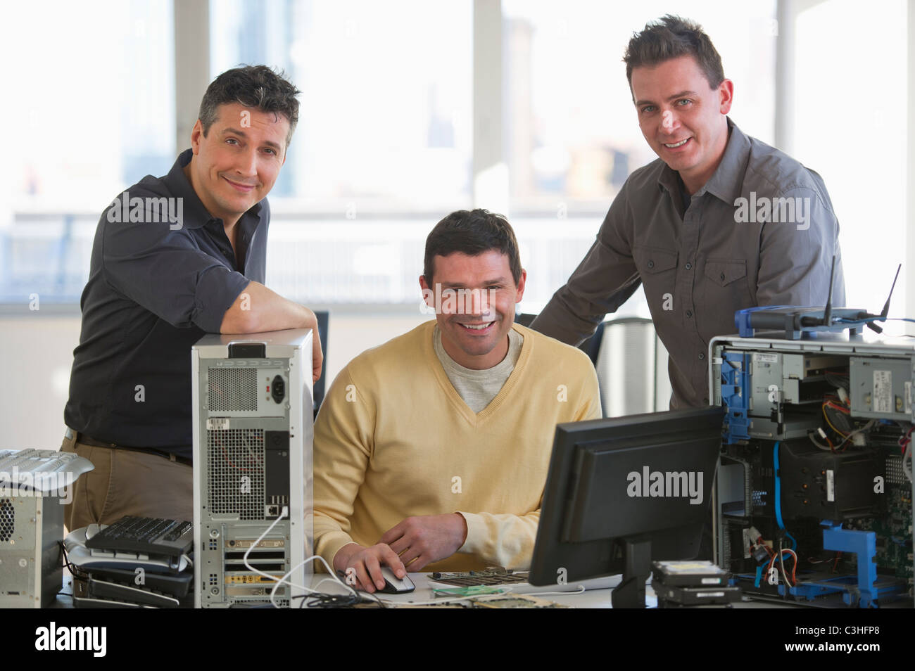 IT Professionals repairing computer in office Stock Photo - Alamy