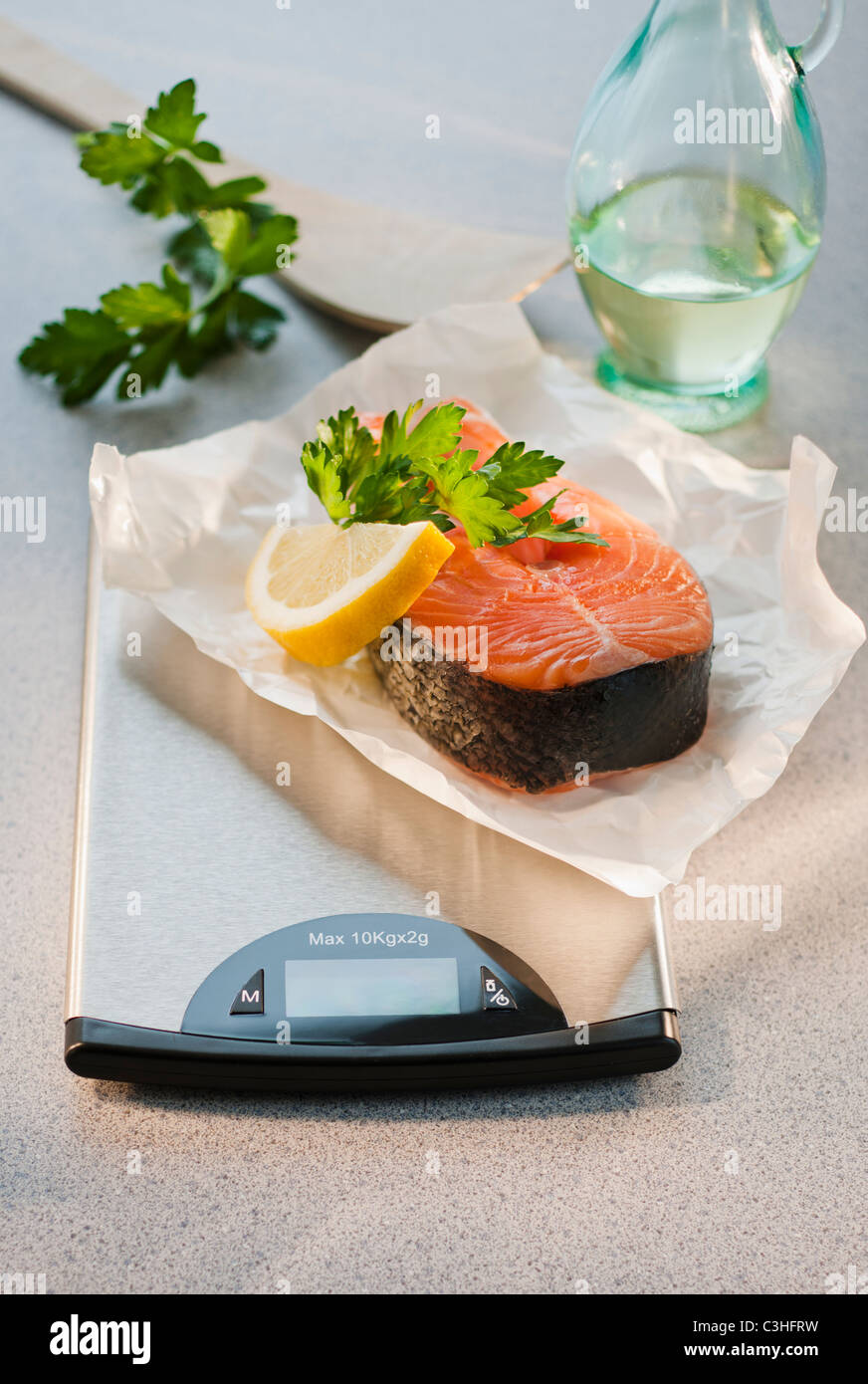Slice of salmon on weight scale Stock Photo - Alamy