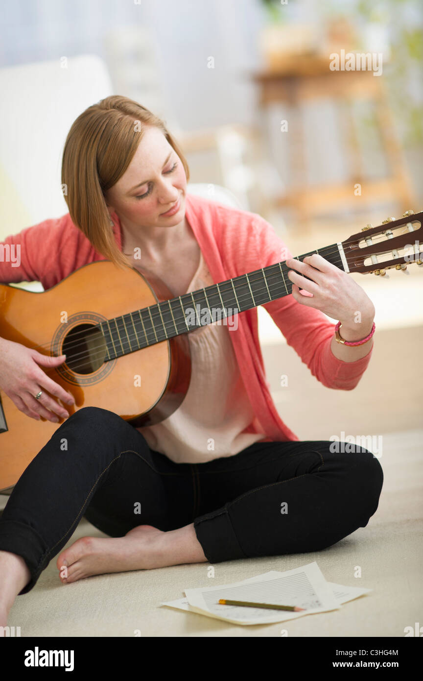 Woman playing guitar Stock Photo - Alamy