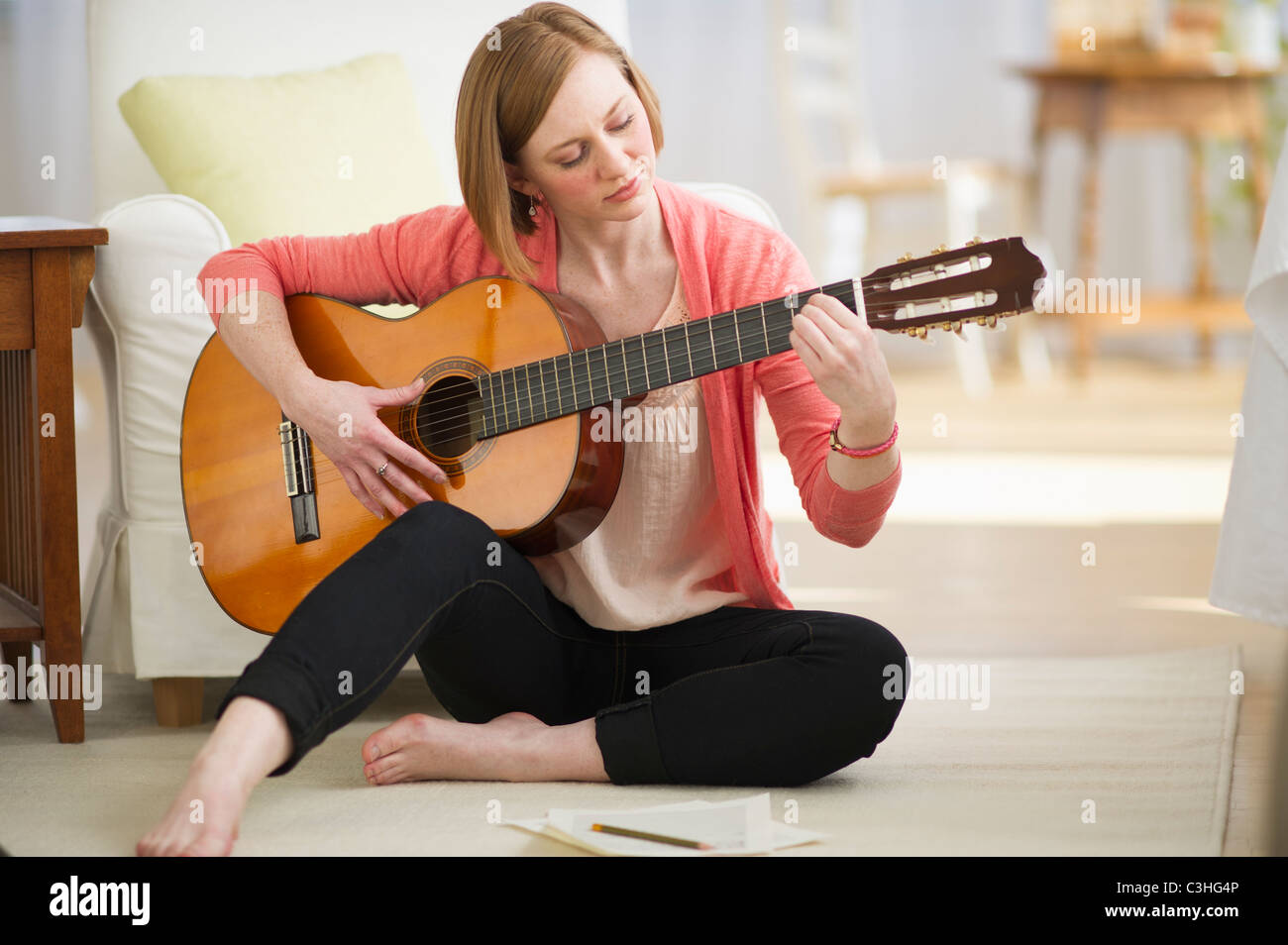 Woman playing guitar Stock Photo - Alamy