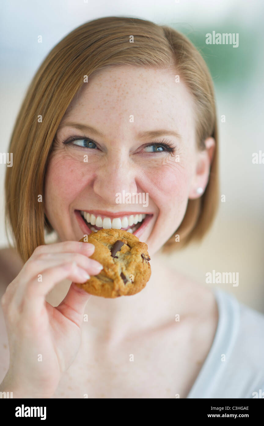 Woman eating cookies Stock Photo - Alamy