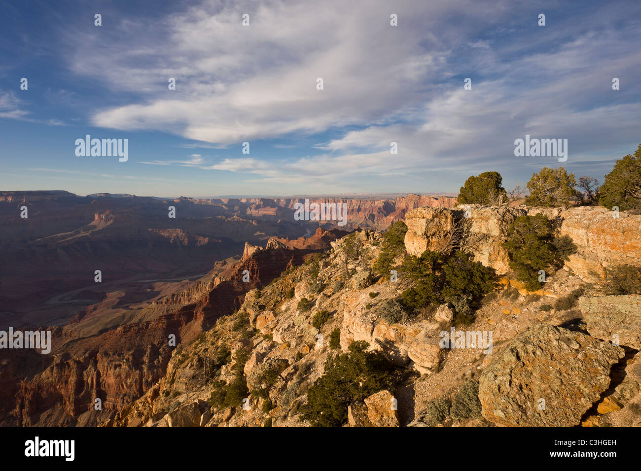 Warm sunset light stikes Lipon Point along the South Rim of the Grand ...