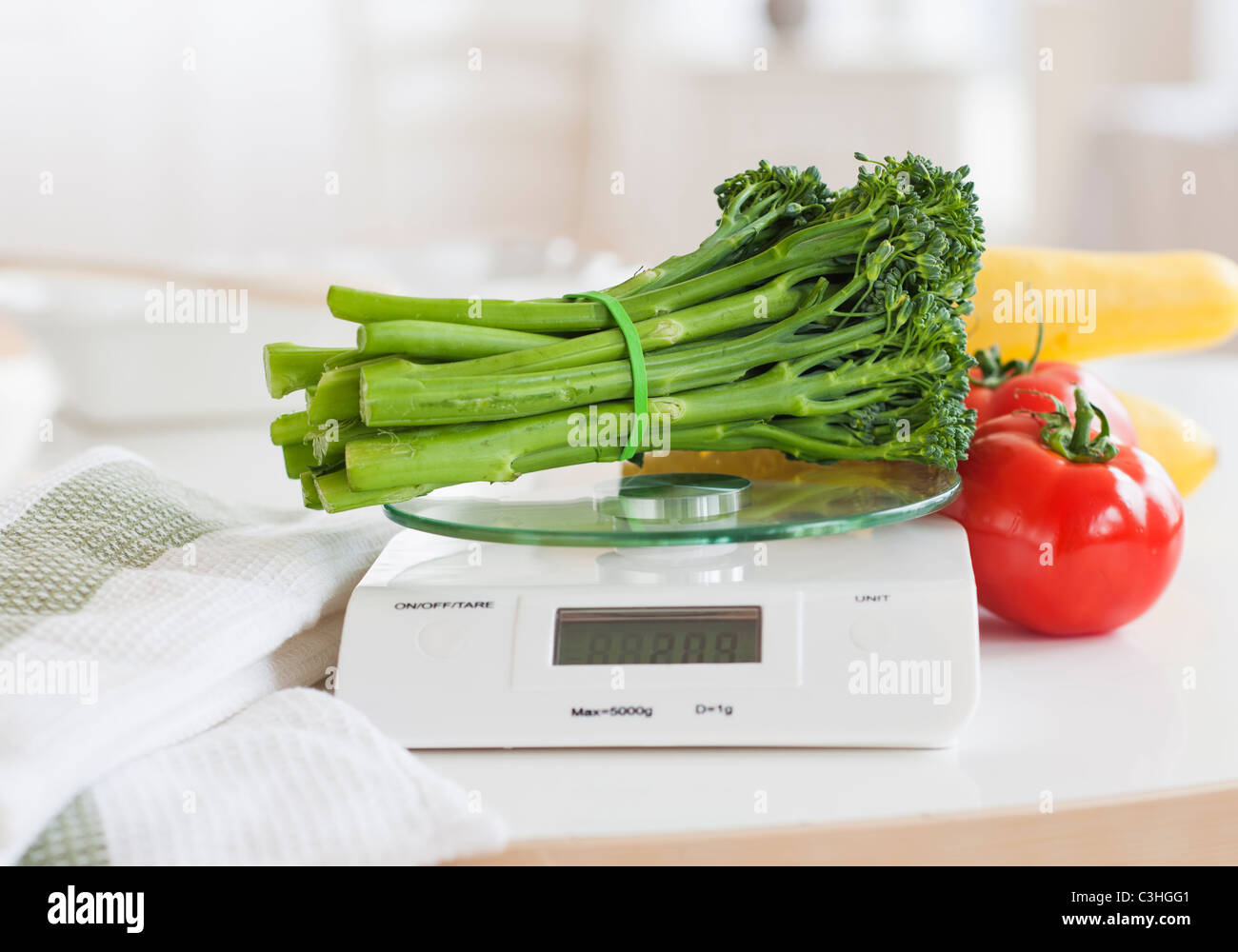 Fresh vegetables on weight scale Stock Photo - Alamy