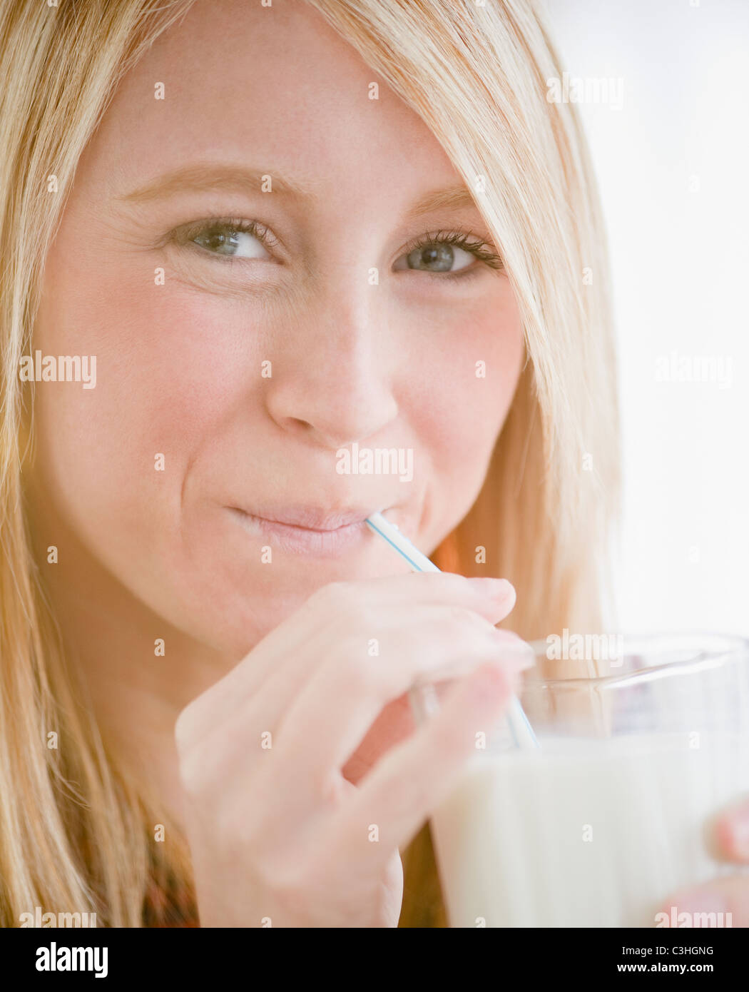 Woman drinking milk Stock Photo - Alamy