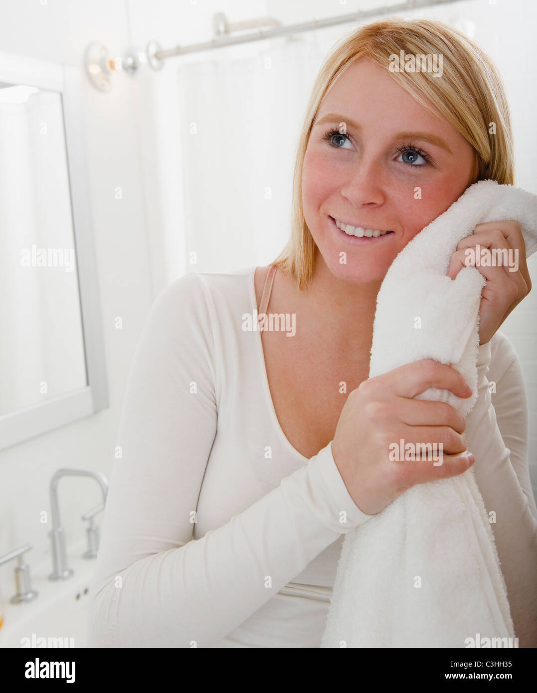 Woman drying face with towel Stock Photo - Alamy