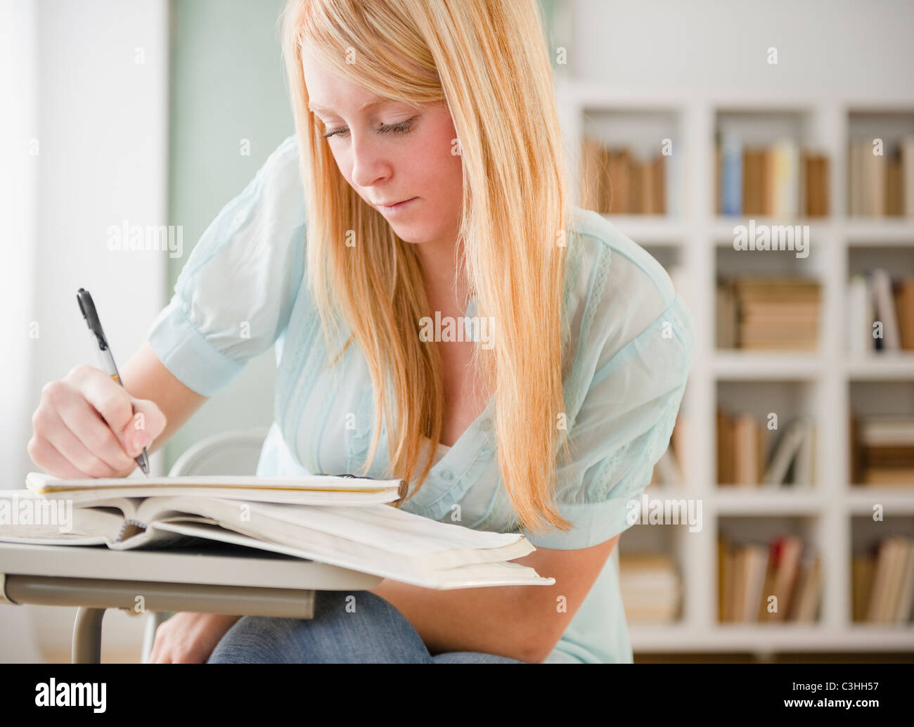 Female student doing homework Stock Photo - Alamy