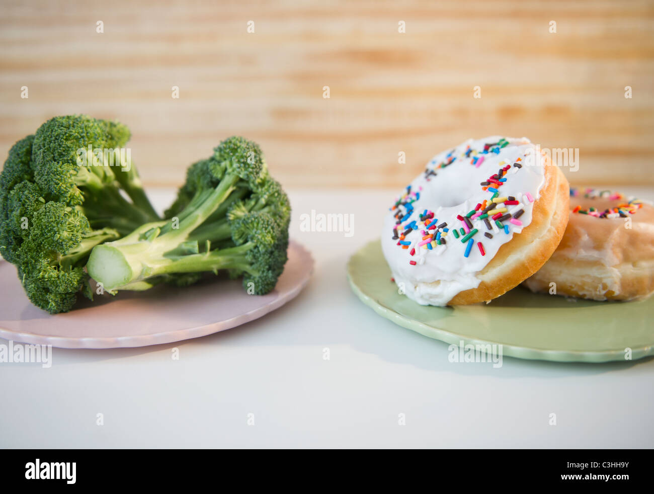 Donuts against broccoli Stock Photo - Alamy