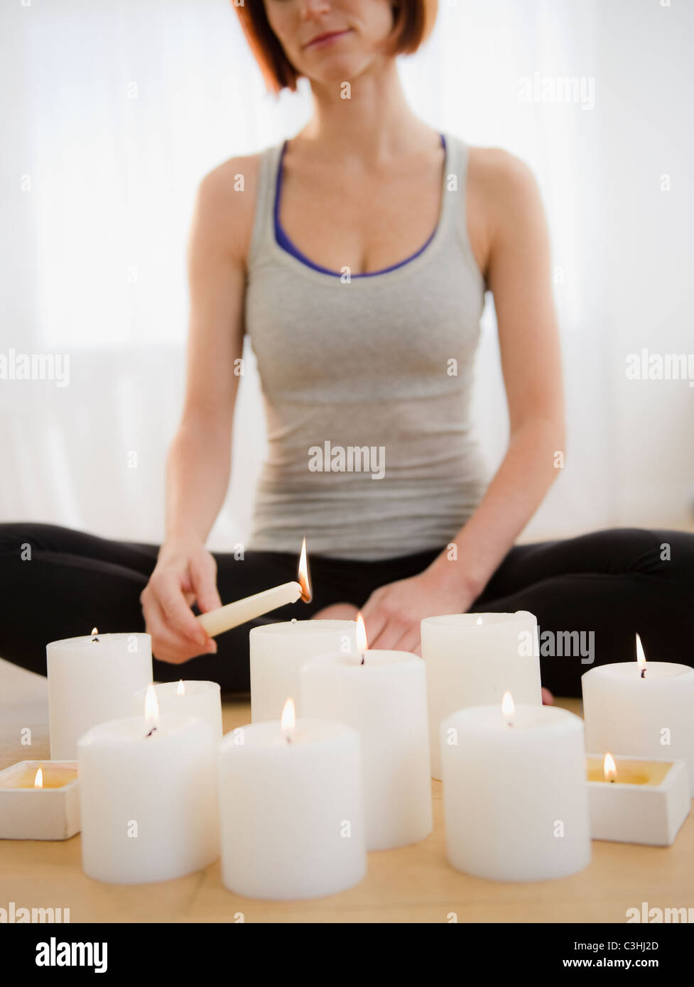 Igniting candles hi-res stock photography and images - Alamy