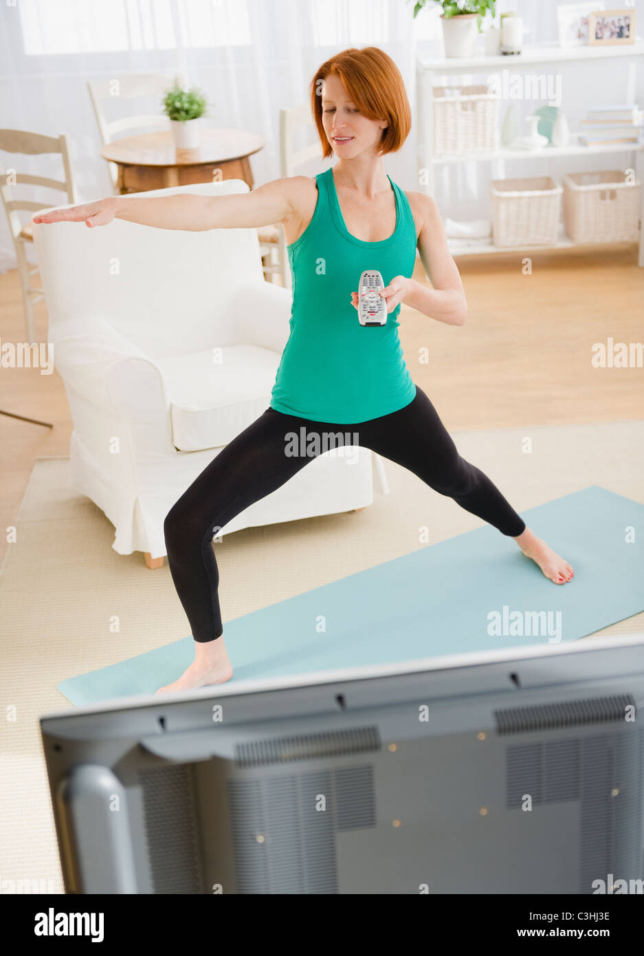 Woman exercising tv hi-res stock photography and images - Alamy