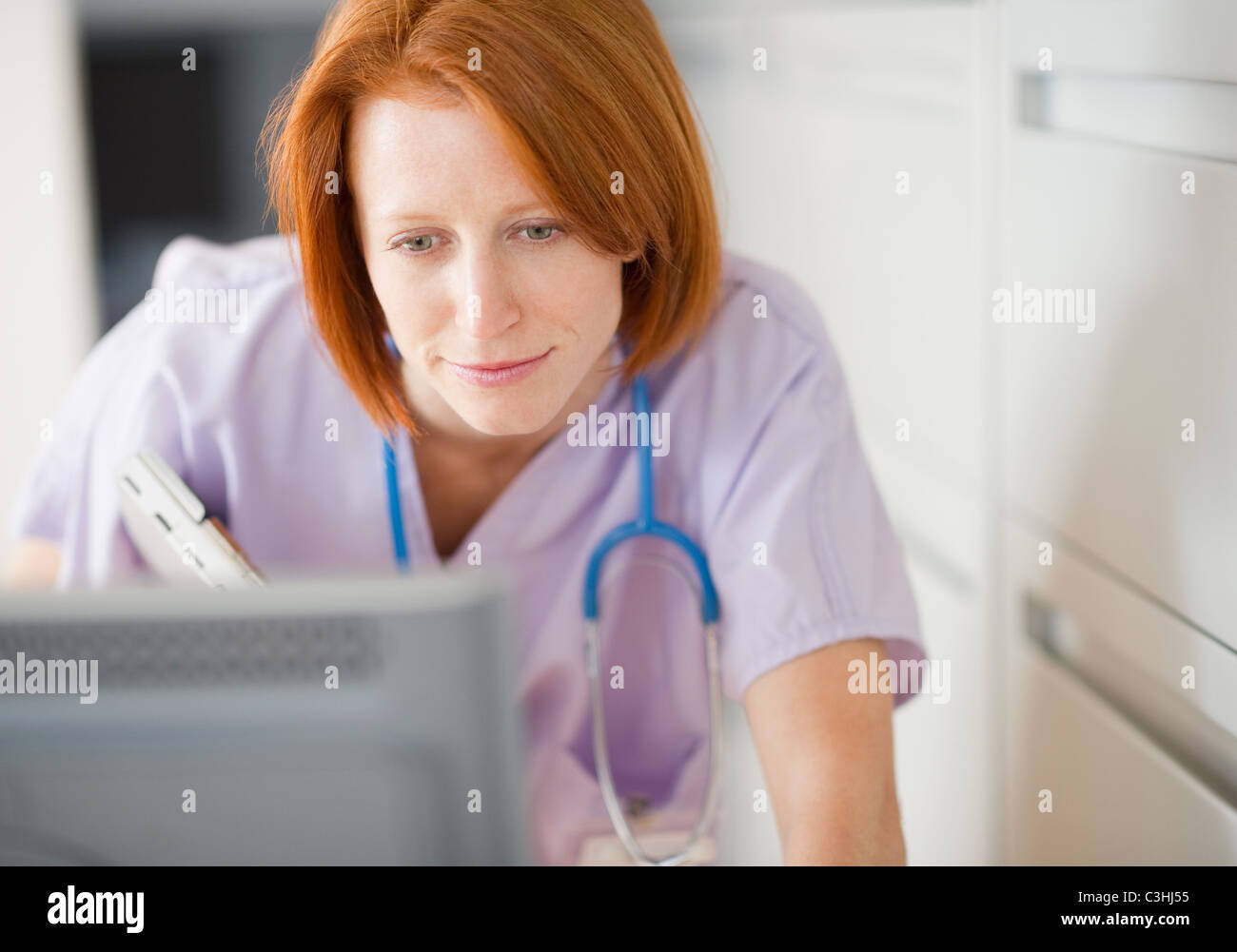 Female nurse using computer Stock Photo - Alamy