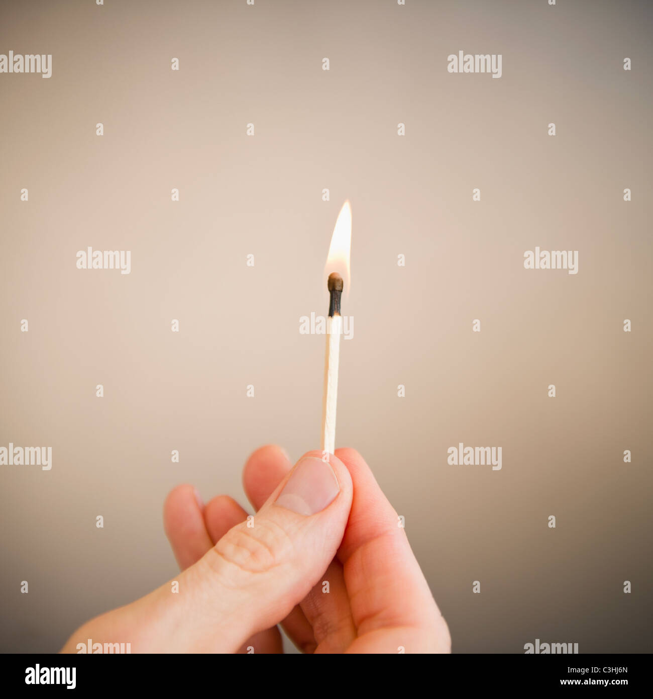 Hand holding match Stock Photo - Alamy