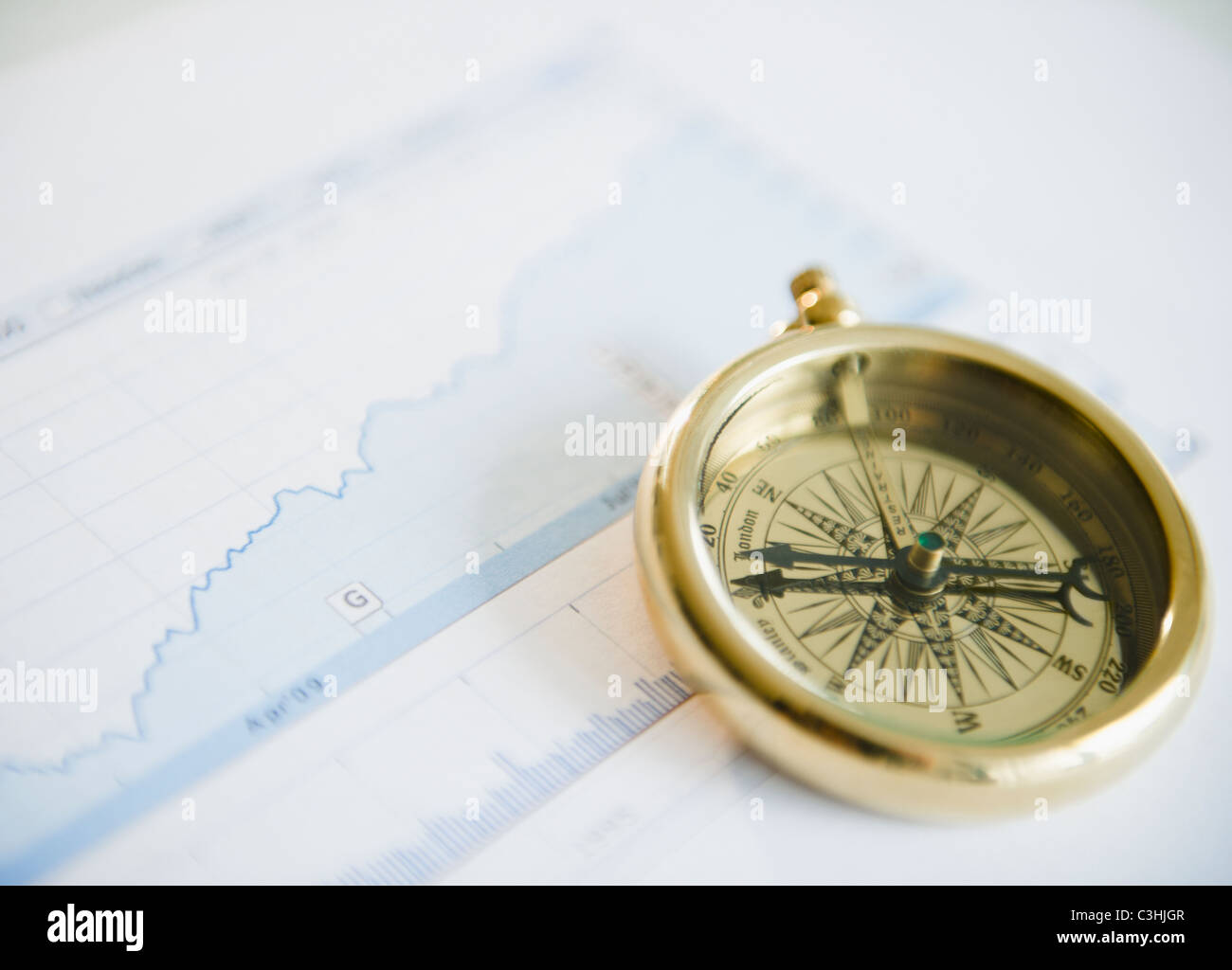 Studio shot of compass on graph Stock Photo - Alamy