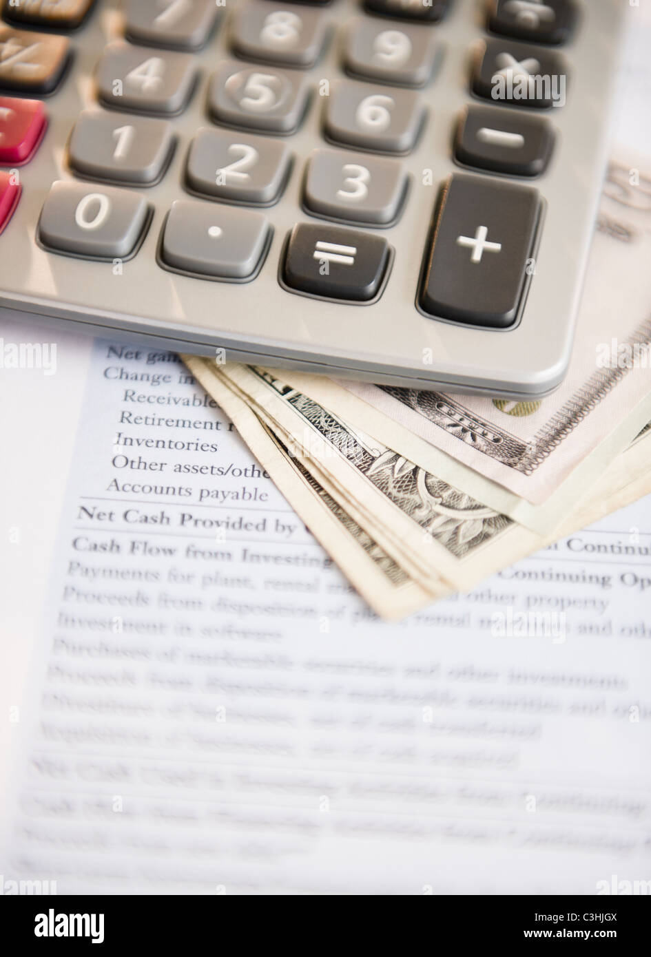 Studio shot of document, money and calculator Stock Photo - Alamy