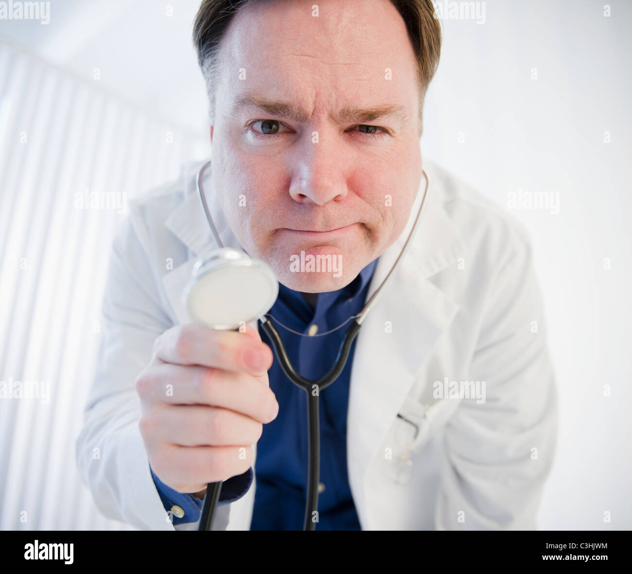 Doctor holding stethoscope Stock Photo - Alamy