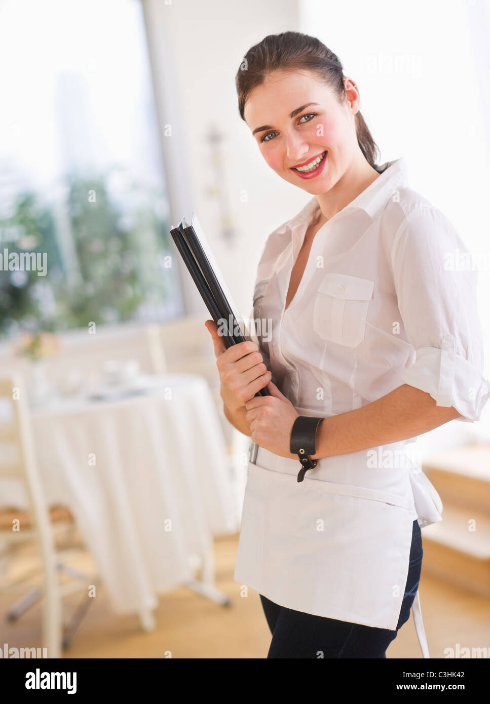 Portrait of young waitress Stock Photo - Alamy
