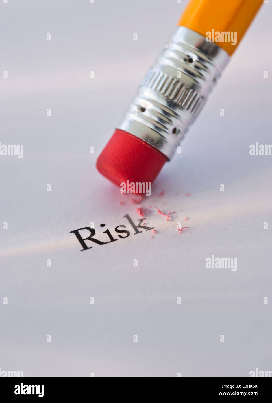 Studio shot of pencil erasing the word risk from piece of paper Stock ...