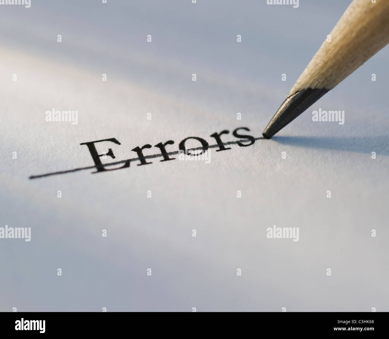 Studio shot of pencil crossing out the word errors from piece of paper ...
