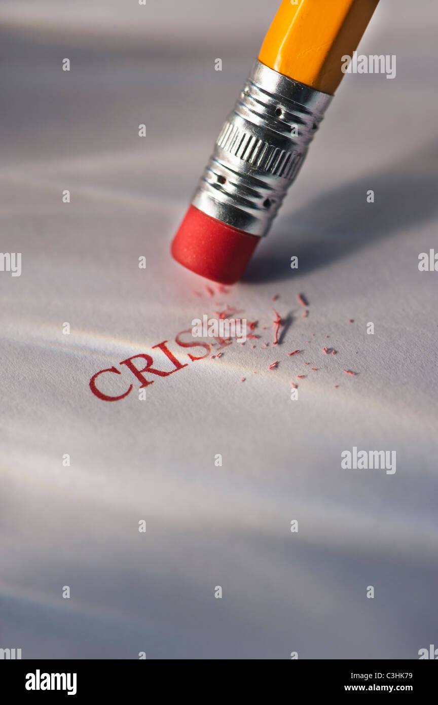 Studio shot of pencil erasing the word crisis from piece of paper Stock ...