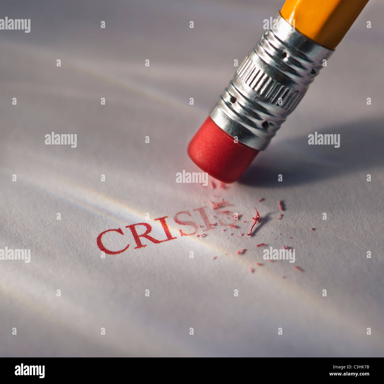 Studio shot of pencil erasing the word crisis from piece of paper Stock ...