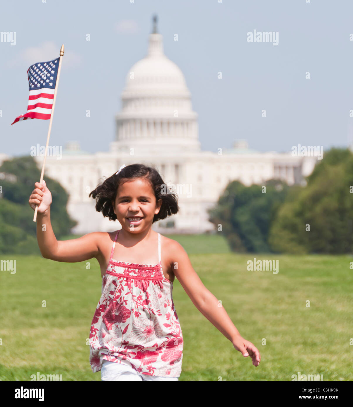 USA, Washington DC, girl (10-11) with US flag running in front of ...