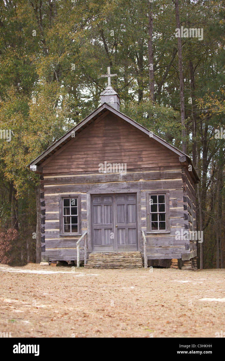 An old log church on a stone foundation on a dirt country road Stock ...