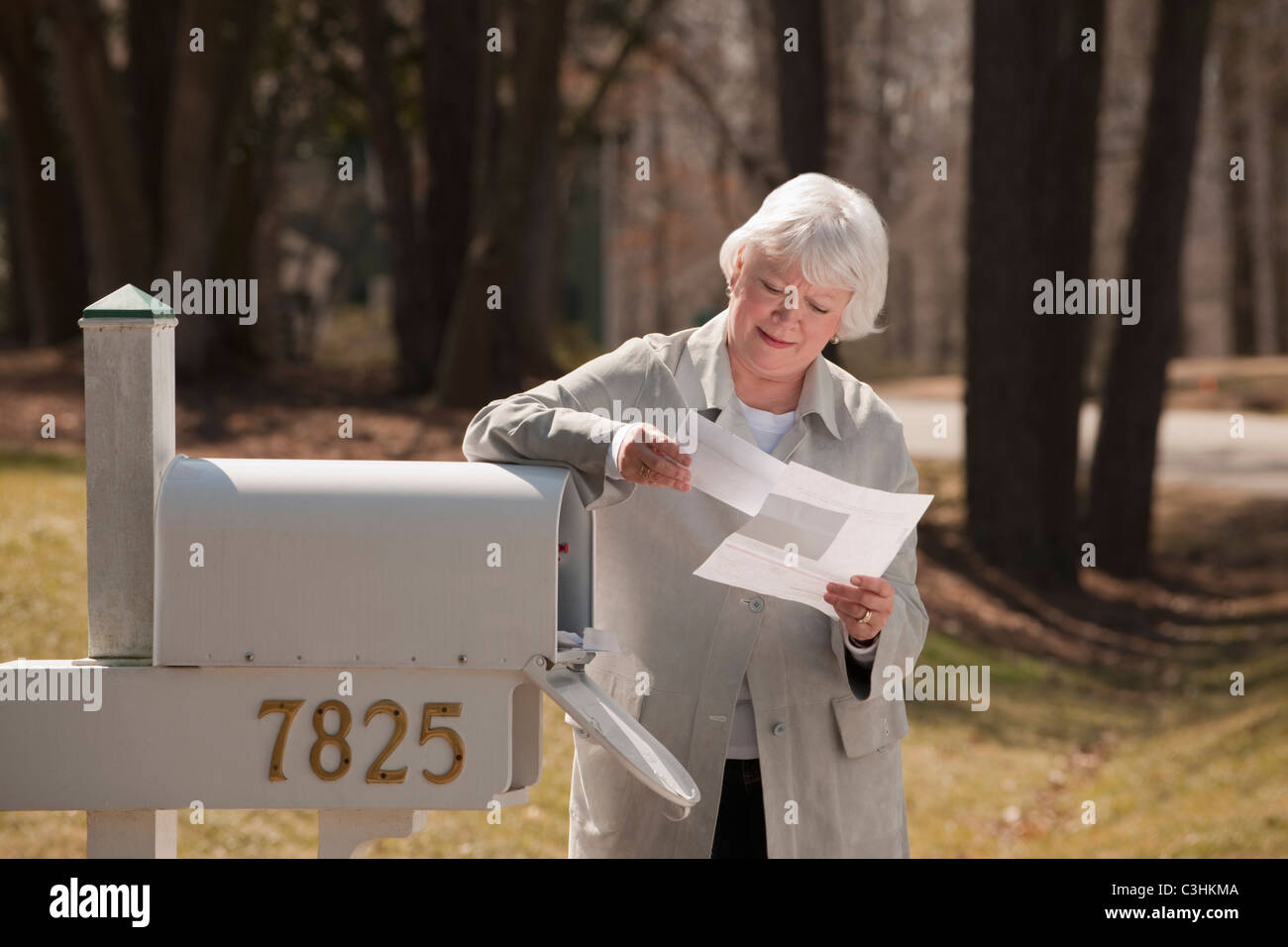 Woman opening mailbox hi-res stock photography and images - Alamy